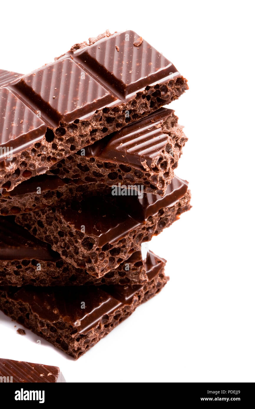 black chocolate blocks closeup on white background Stock Photo - Alamy