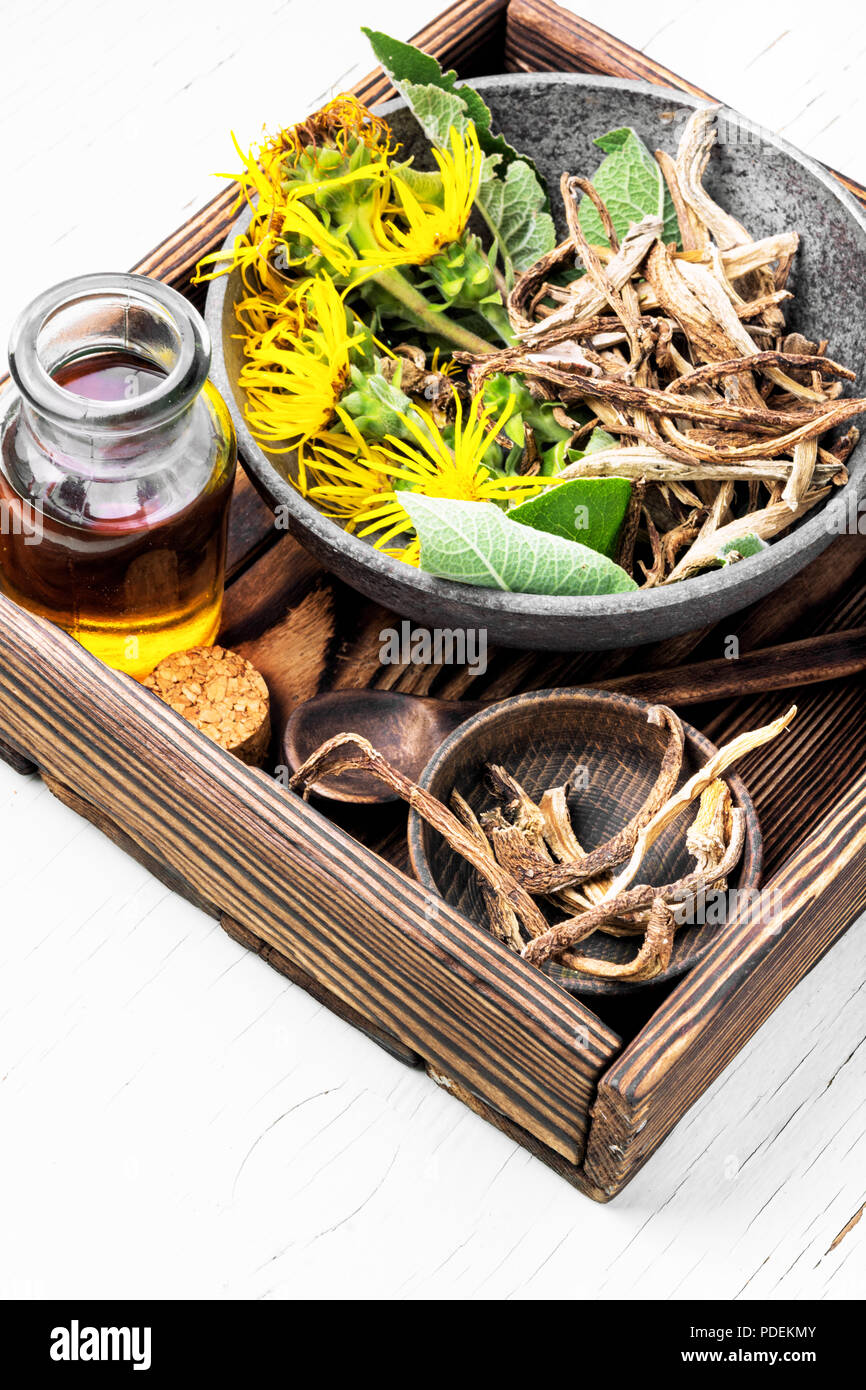 Healing elixir from the root of inula Stock Photo - Alamy