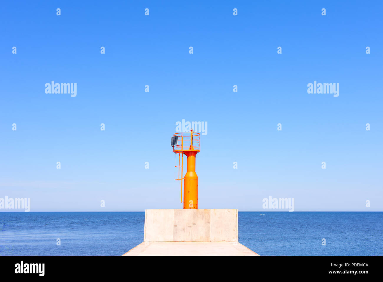 Baltic sea, Latvia. Modern orange beacon on a flat horizon against a ...