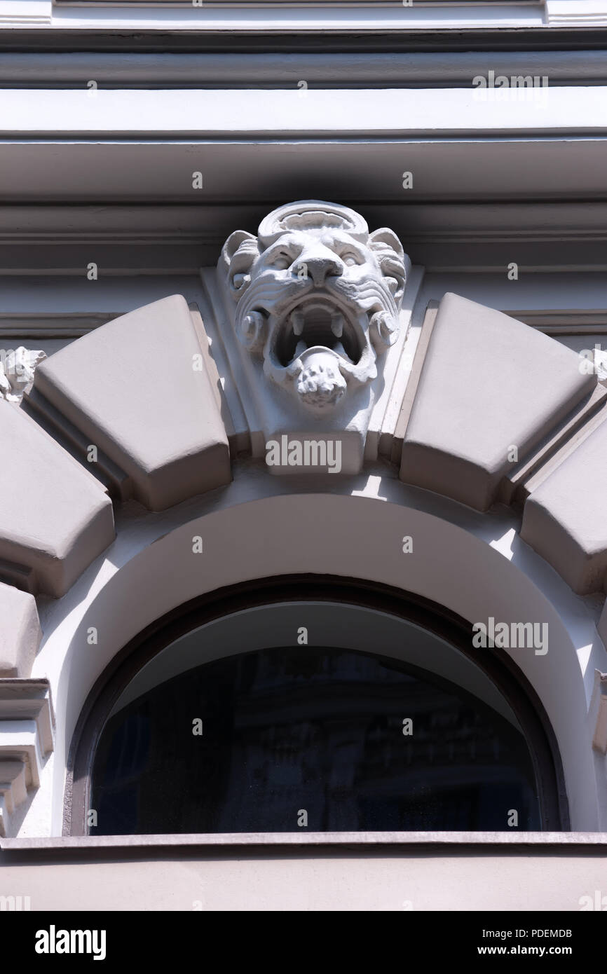 The bas-relief of a lion on the wall above the window Stock Photo - Alamy