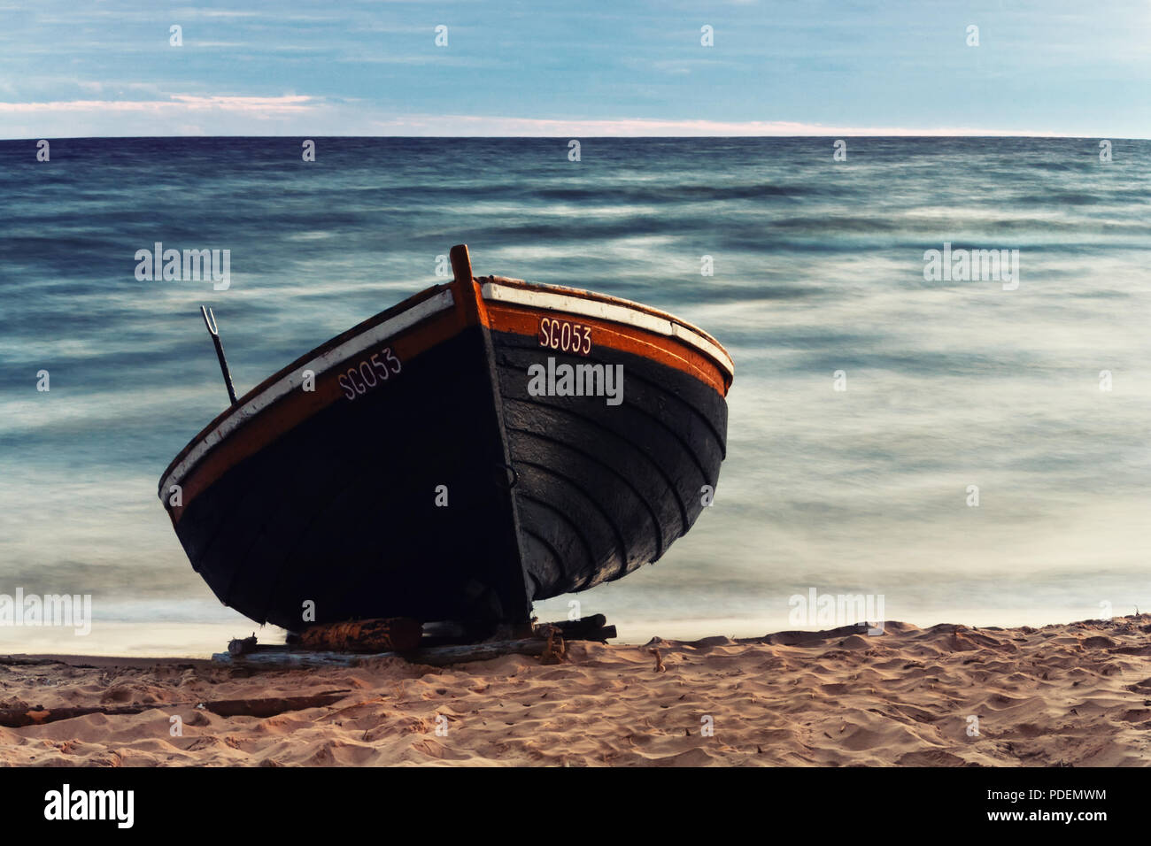 Wooden boat on the beach Stock Photo - Alamy