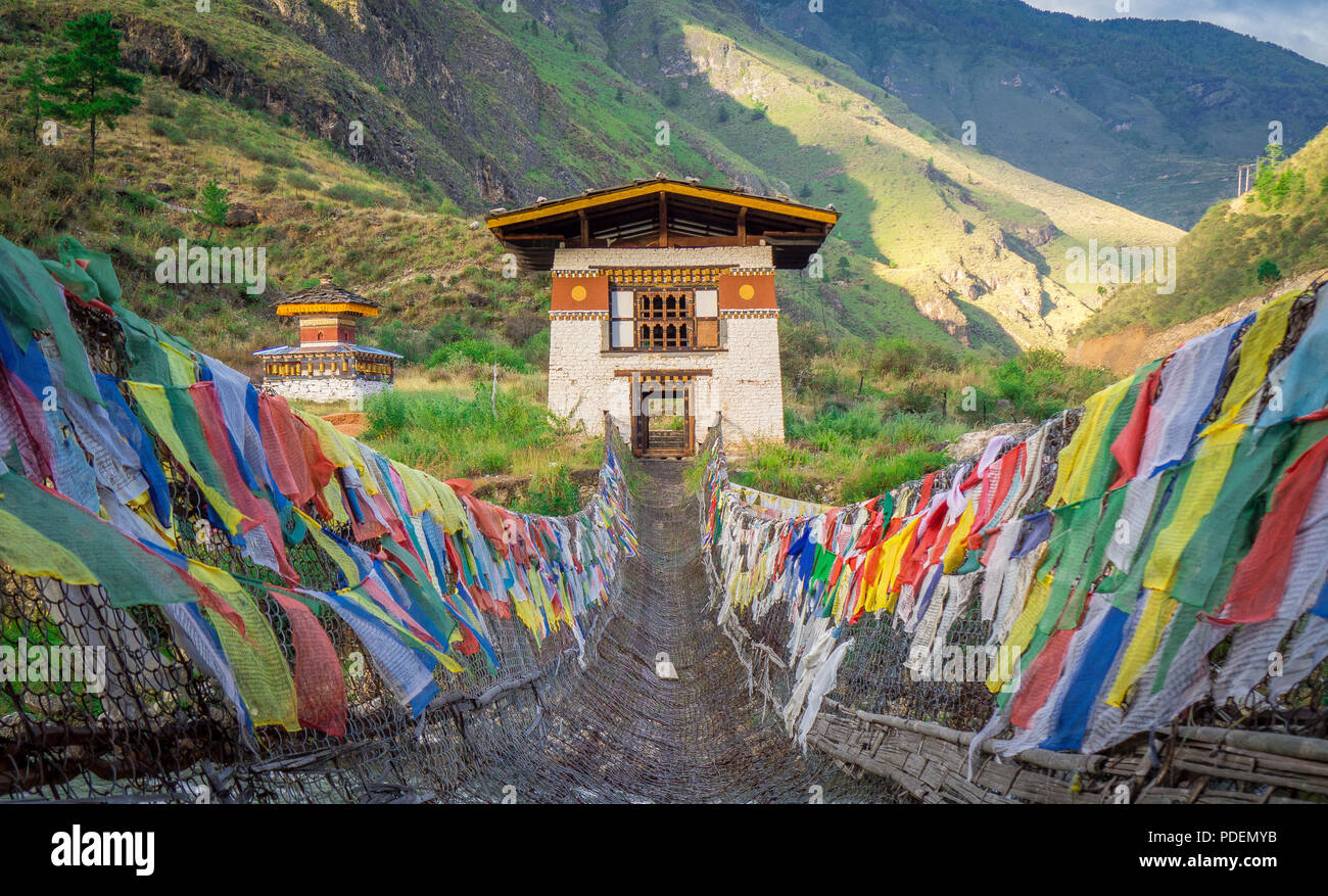 Hanging bridge with colourful Buddhist prayer flags in Paro Bhutan ...