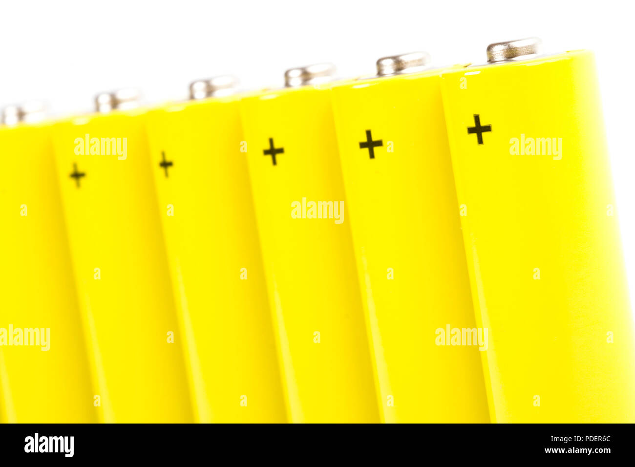 yellow alkaline batteries closeup on white background Stock Photo - Alamy