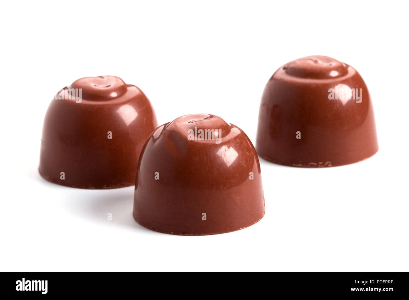 three chocolate sweets isolated on a white background Stock Photo - Alamy
