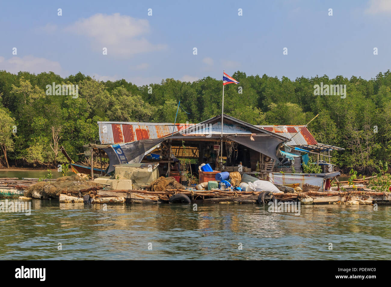 Float fishing village on tropical river with trees on background in ...