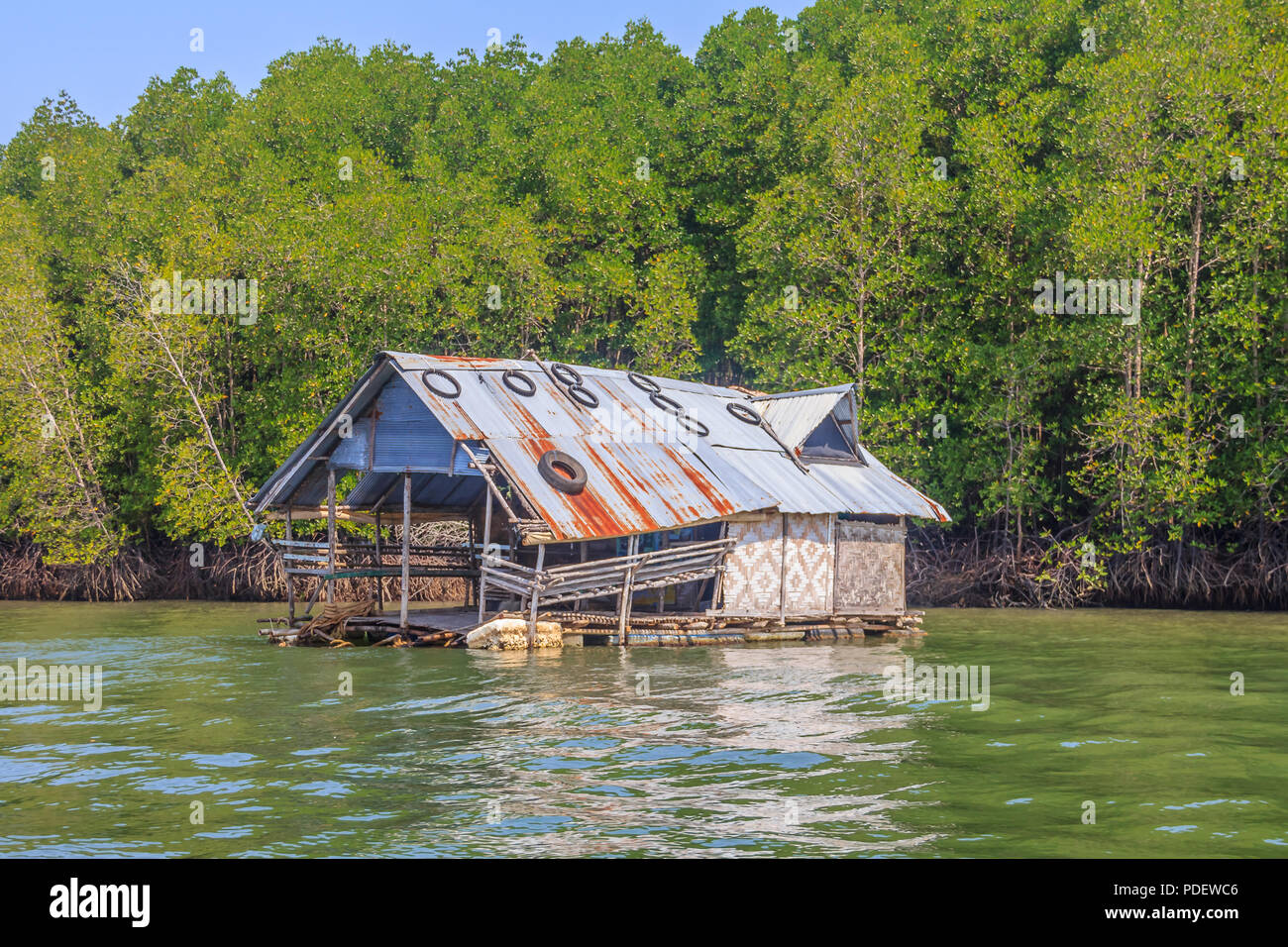 Float fishing village on tropical river with trees on background in ...