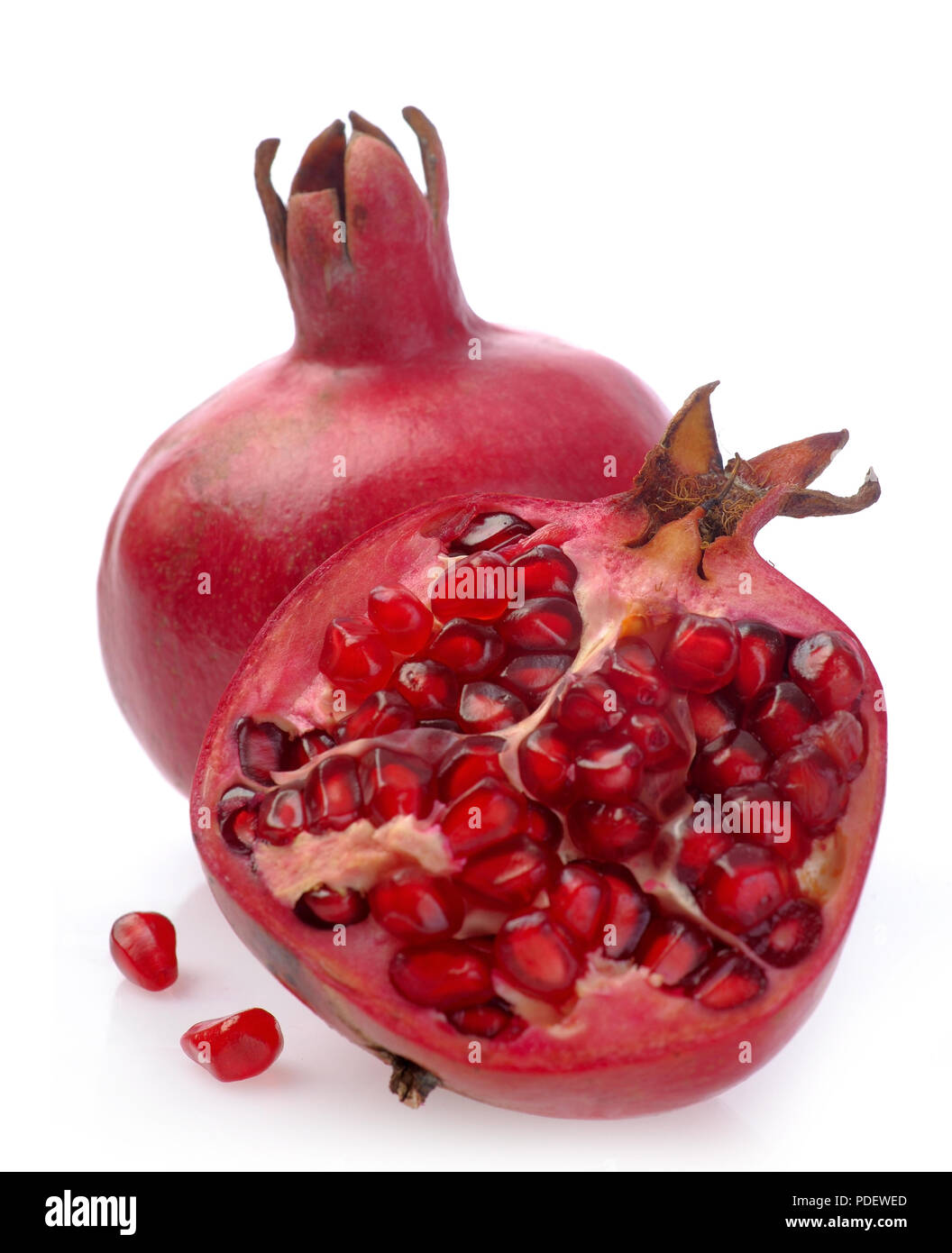 Pomegranate whole and open-face with seeds on a white background Stock ...