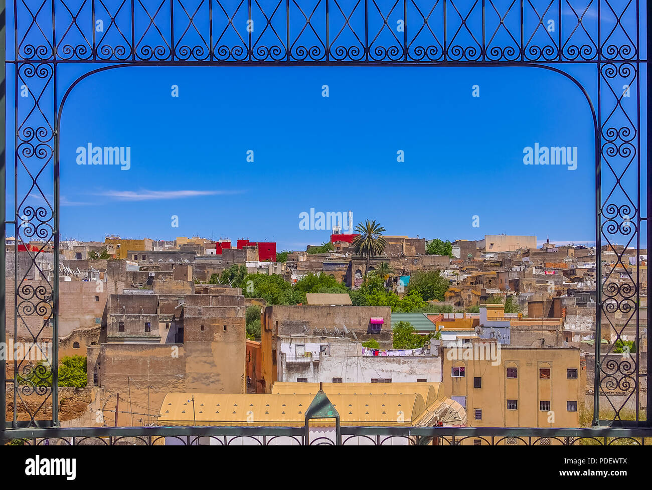 View over the ancient yellow clay rooftops of the Fes medina through an ...