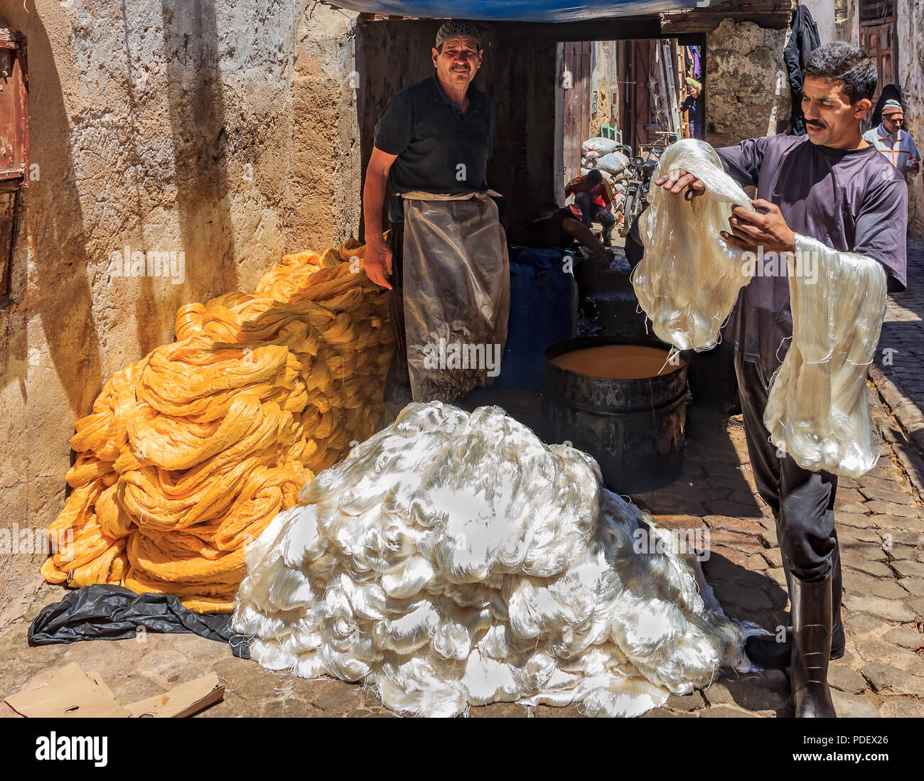 Fes, Morocco - May 11, 2013: Men coloring Moroccan silk thread with dye ...