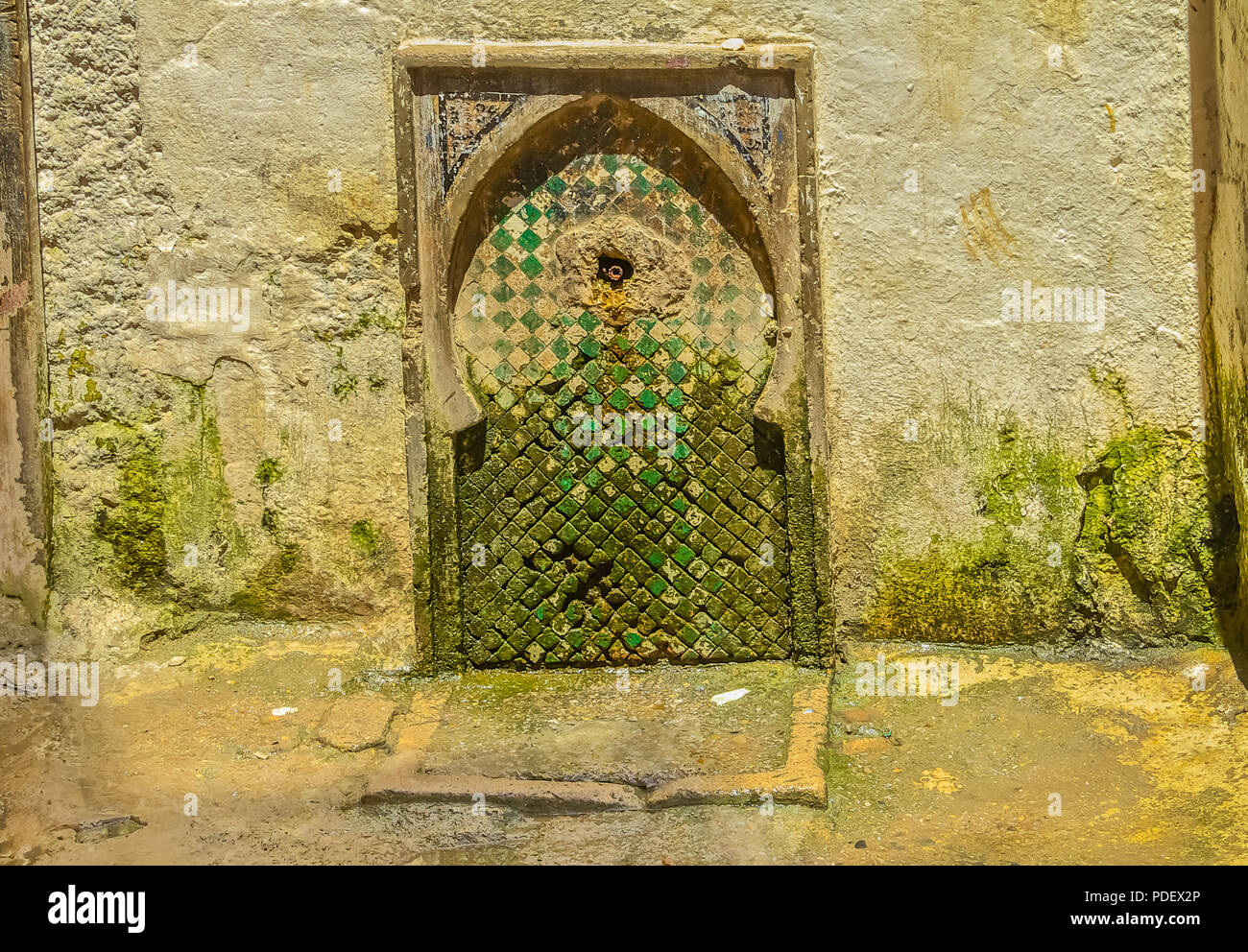 Old fountain covered in traditional mosaic in the medina of Fes ...