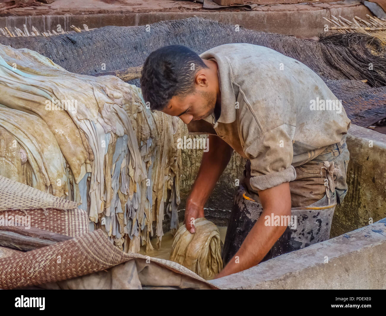 Marrakech, Morocco - December, 08, 2012: Worker handling hides at a ...