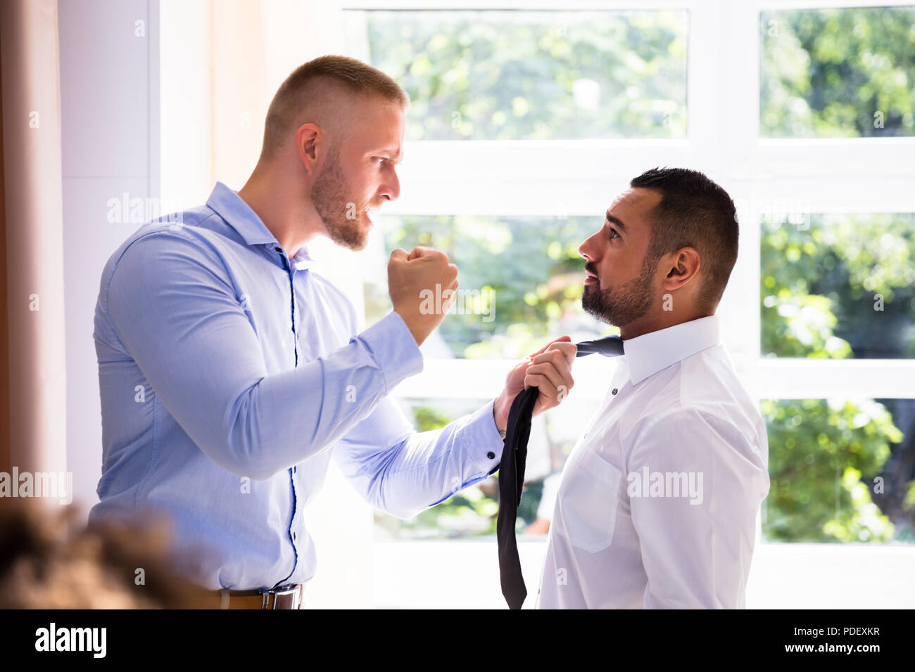 Side View Of A Angry Young Businessman Fighting With His Coworker Stock ...