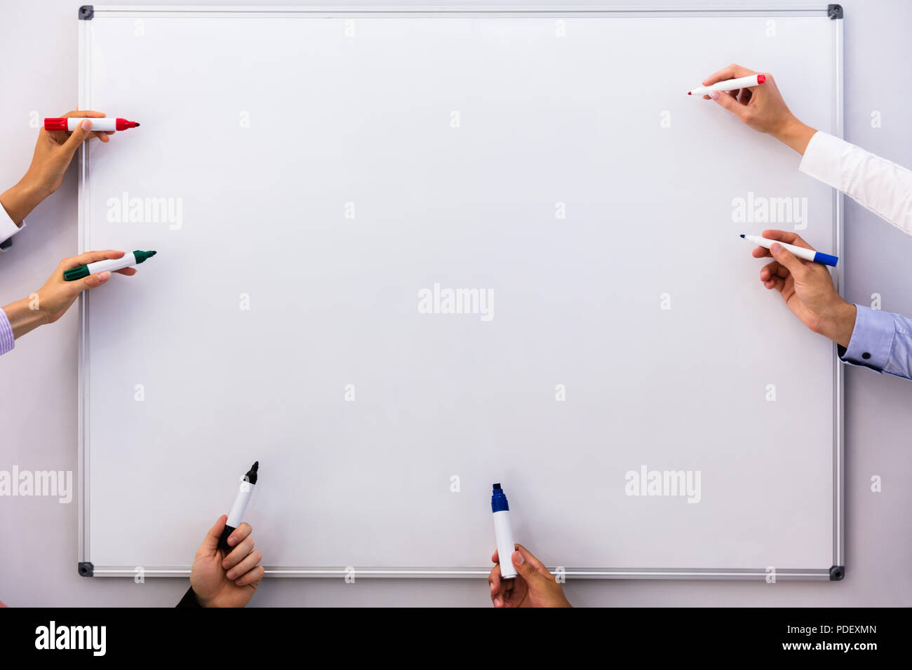 Businesspeople Writing On Blank White Board With Markers Stock Photo ...