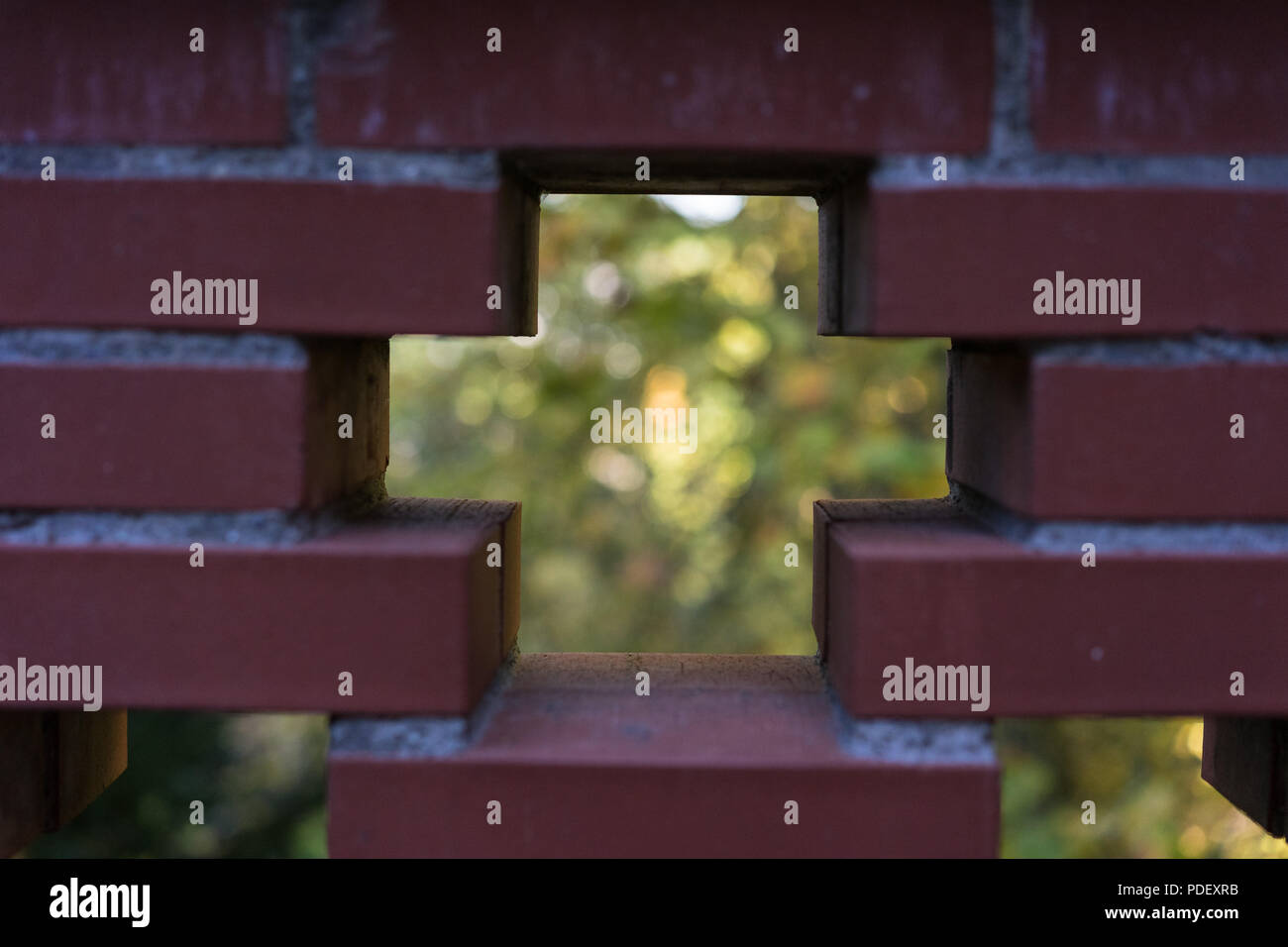red brick wall see through with cross and garden background abstracht ...