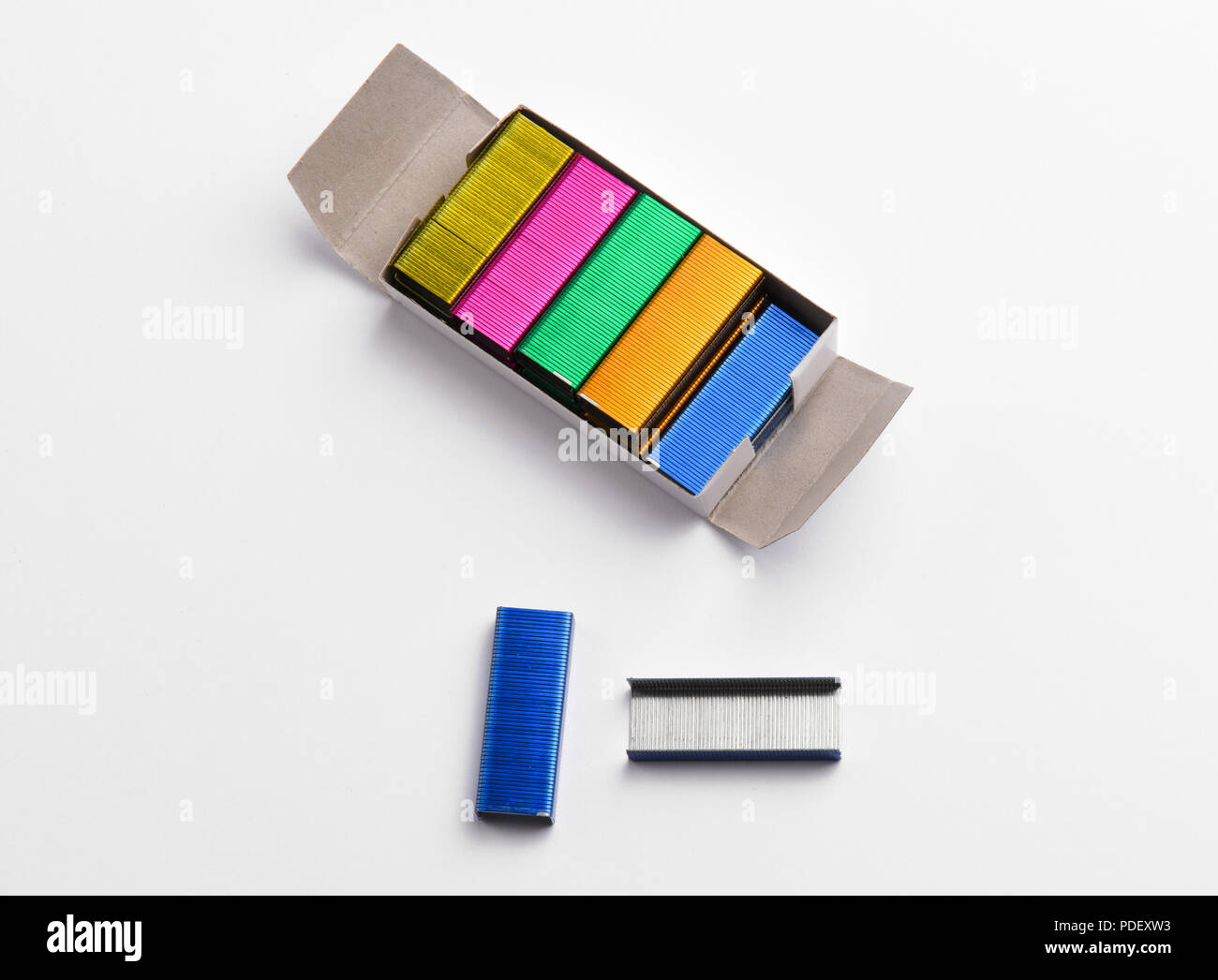 Colourful metal staples in cardboard box Stock Photo - Alamy