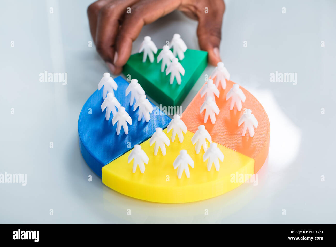 Close-up Of Human Hand Taking Green Piece Of Pie Chart With Many White ...