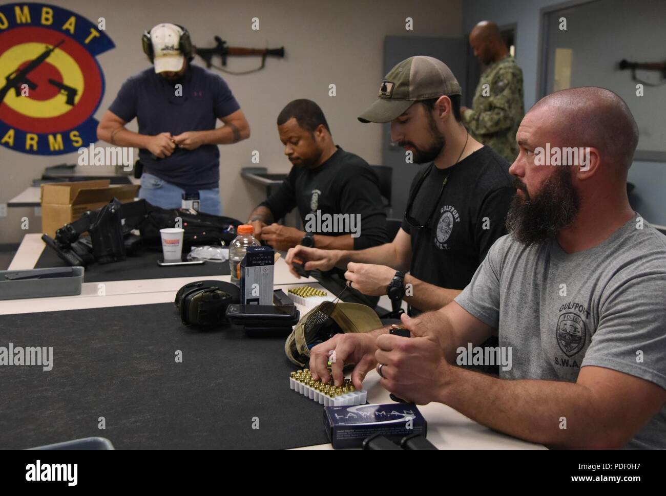 Members of the Gulfport Police Department prepare their weapons for the ...