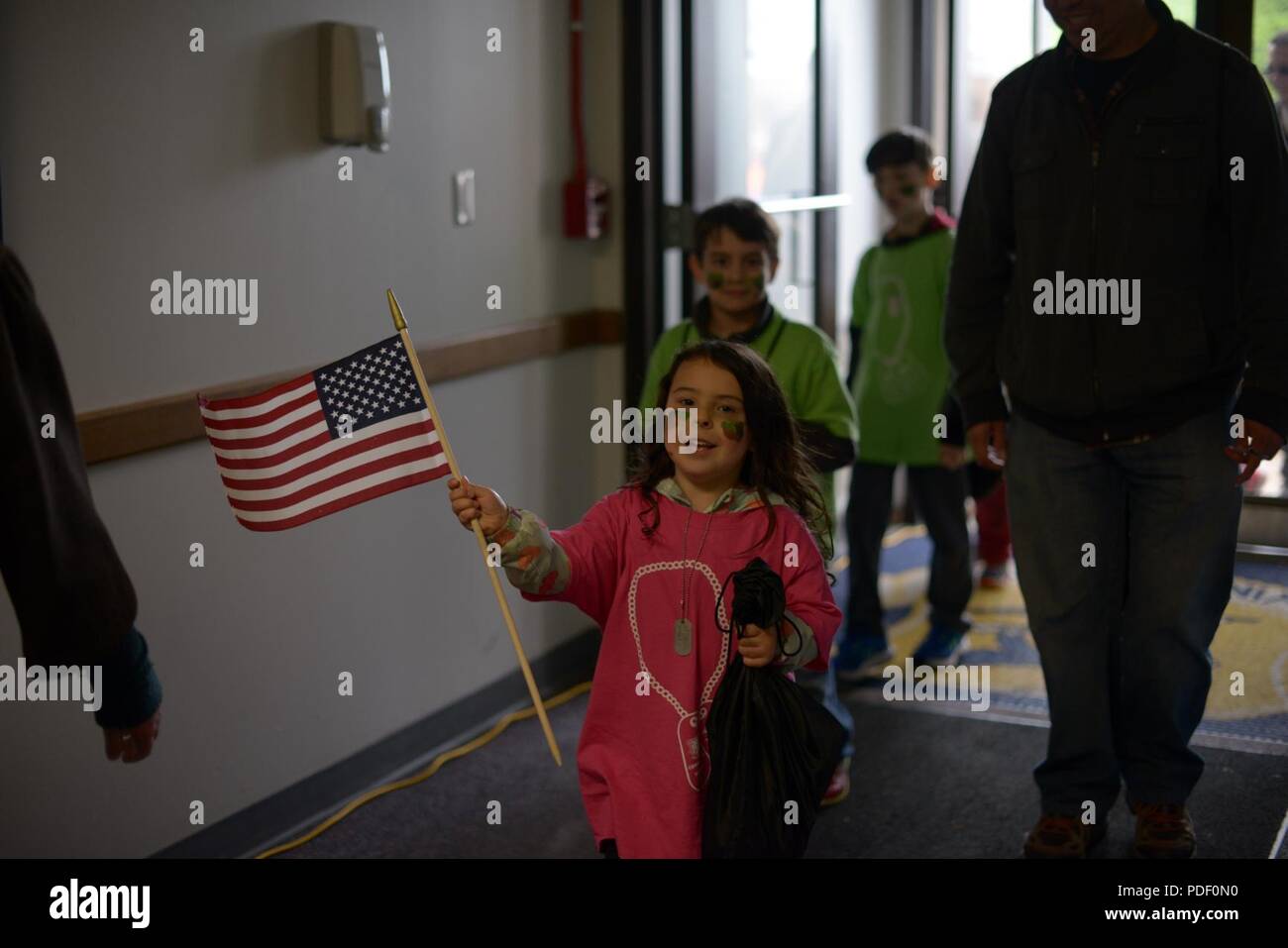 A child of a Connecticut National Guardsman waves an American Flag ...