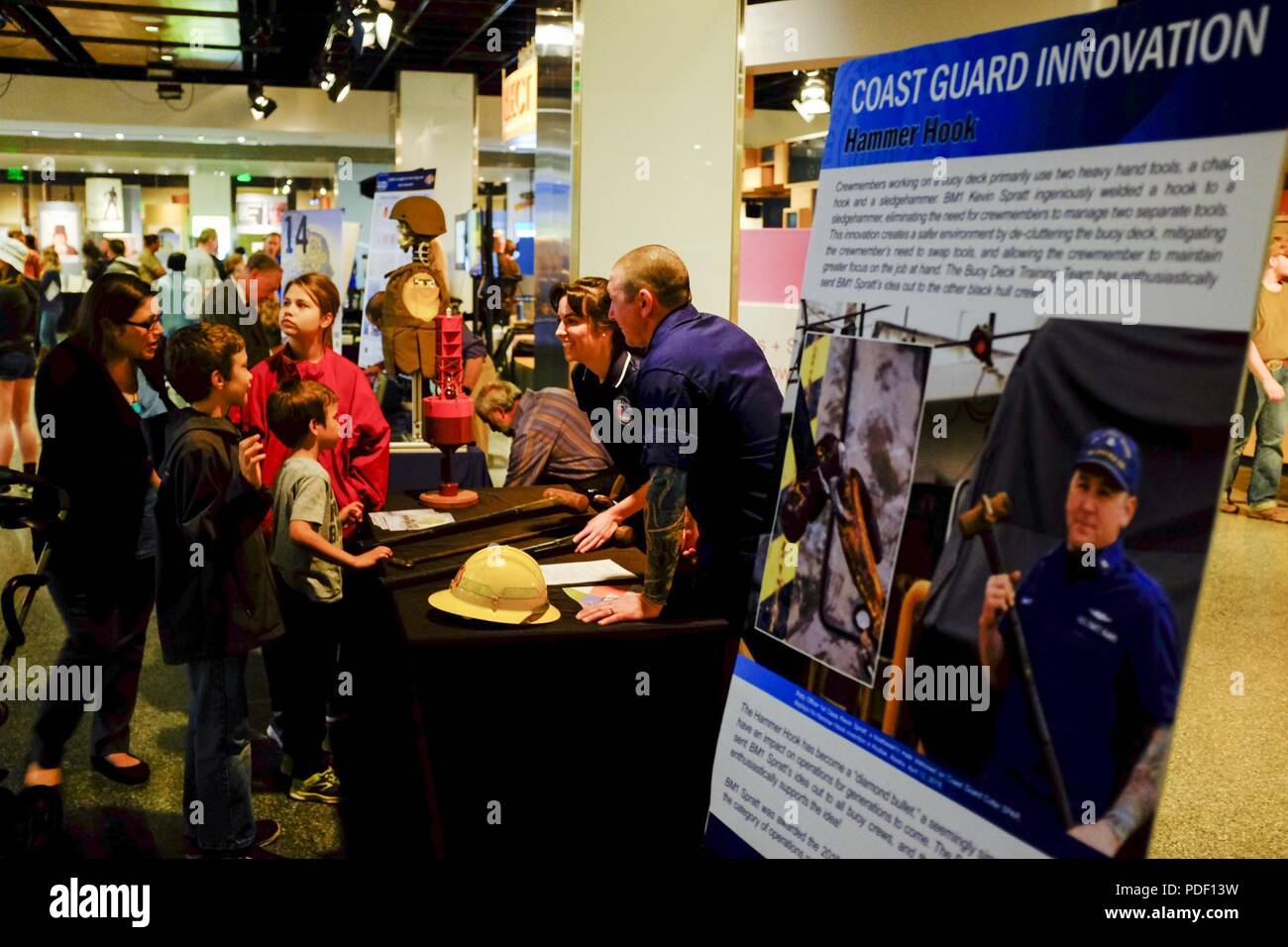 Petty Officer 1st Class Kevin Spratt demonstrates the use of his hammer ...
