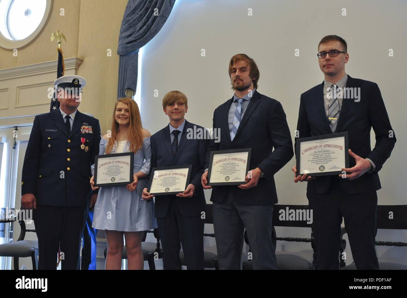 Master Chief Petty Officer Eric Johnson presents his children Jackie ...