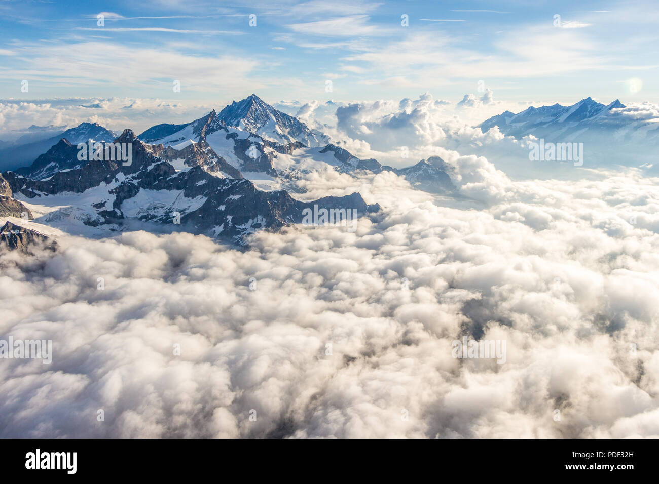 A view of stunning peaks above a sea of clouds on a clear day Stock ...