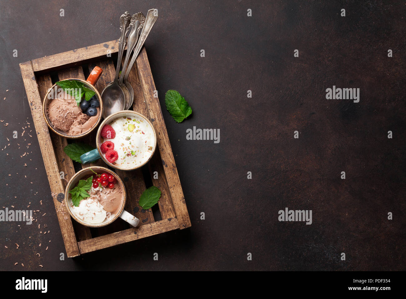 Ice cream with berries in wooden box. Top view with space for your text ...