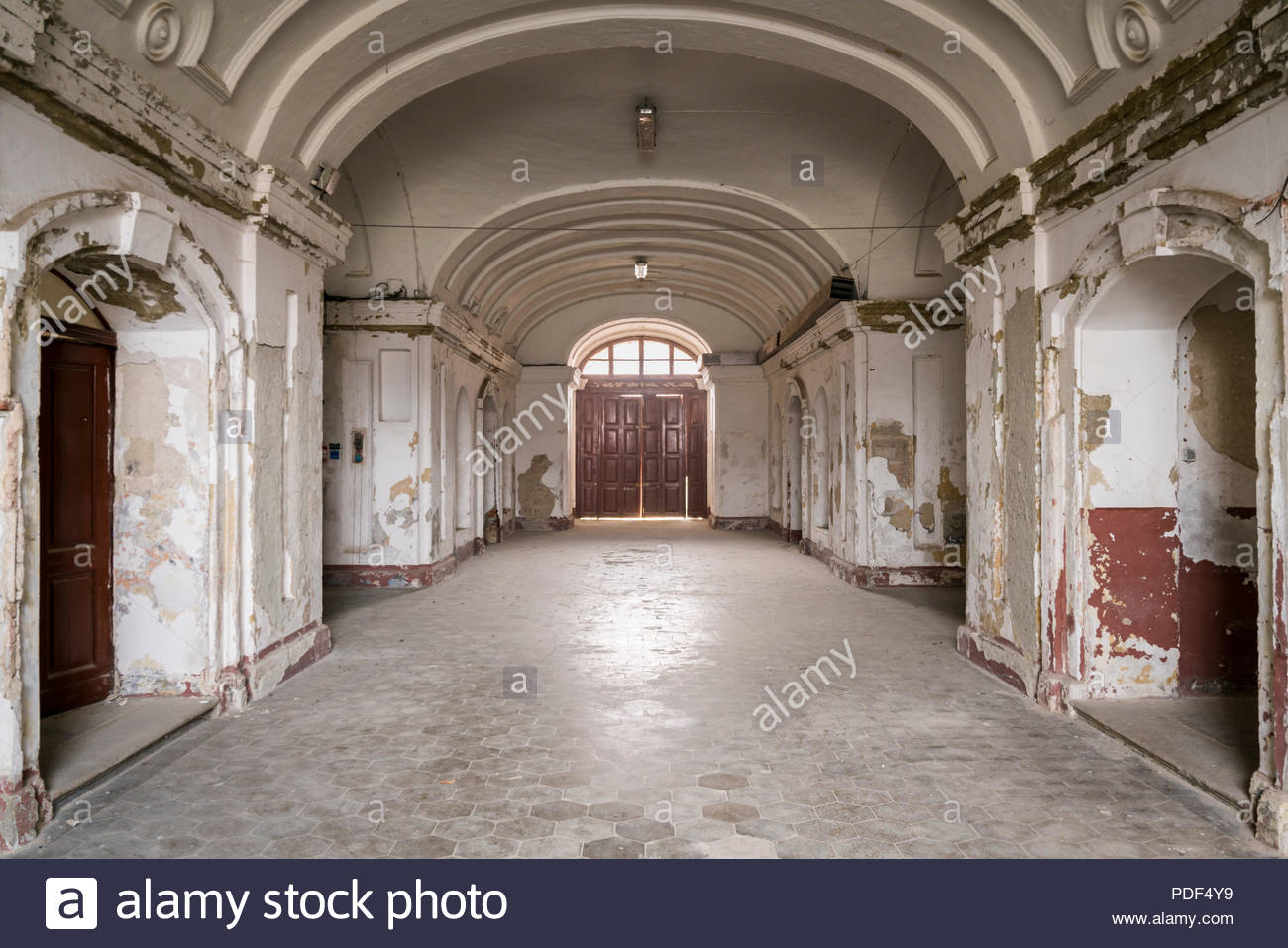 Decaying interior of an abandoned building with peeling paint and ...