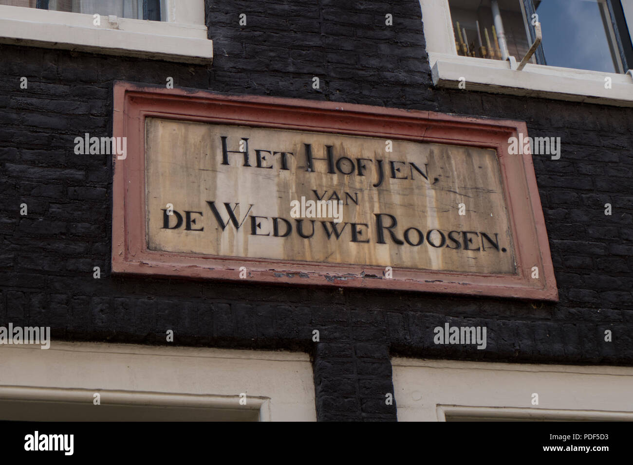 Aspect of typical Dutch gabled roof house with inscription in Amsterdam ...