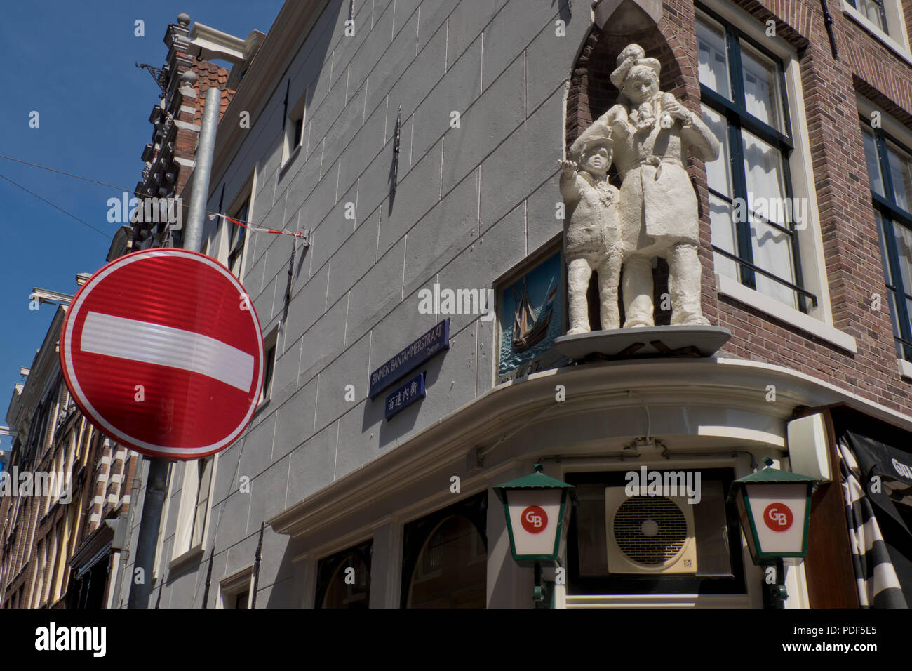 Aspect of typical Dutch gabled roof house with inscription and statue ...