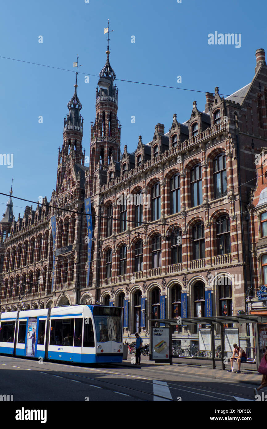 Aspect of typical Dutch office building with tram and passengers in ...