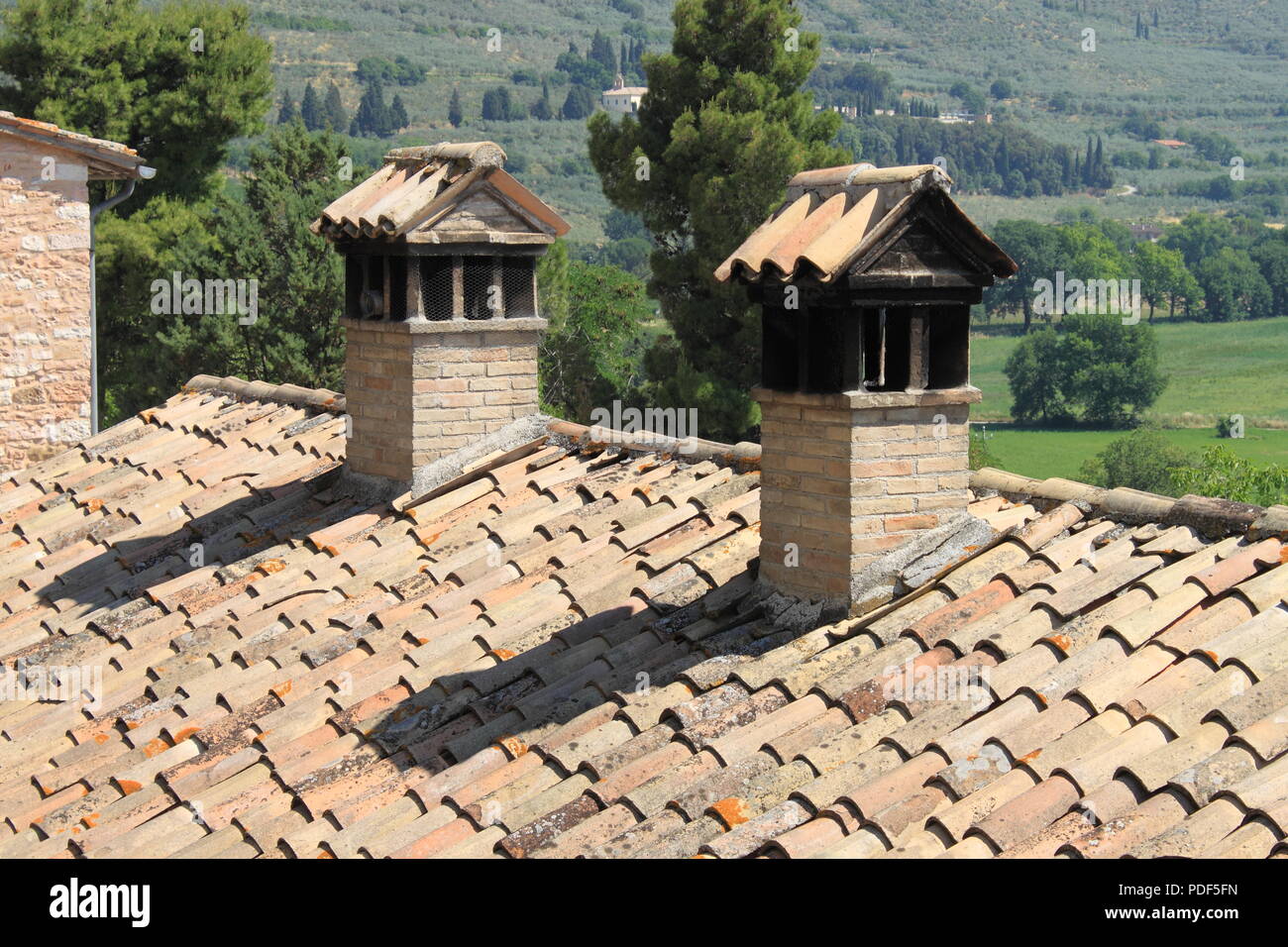 Old traditional rooftop chimneys constructed of bricks on a traditional ...