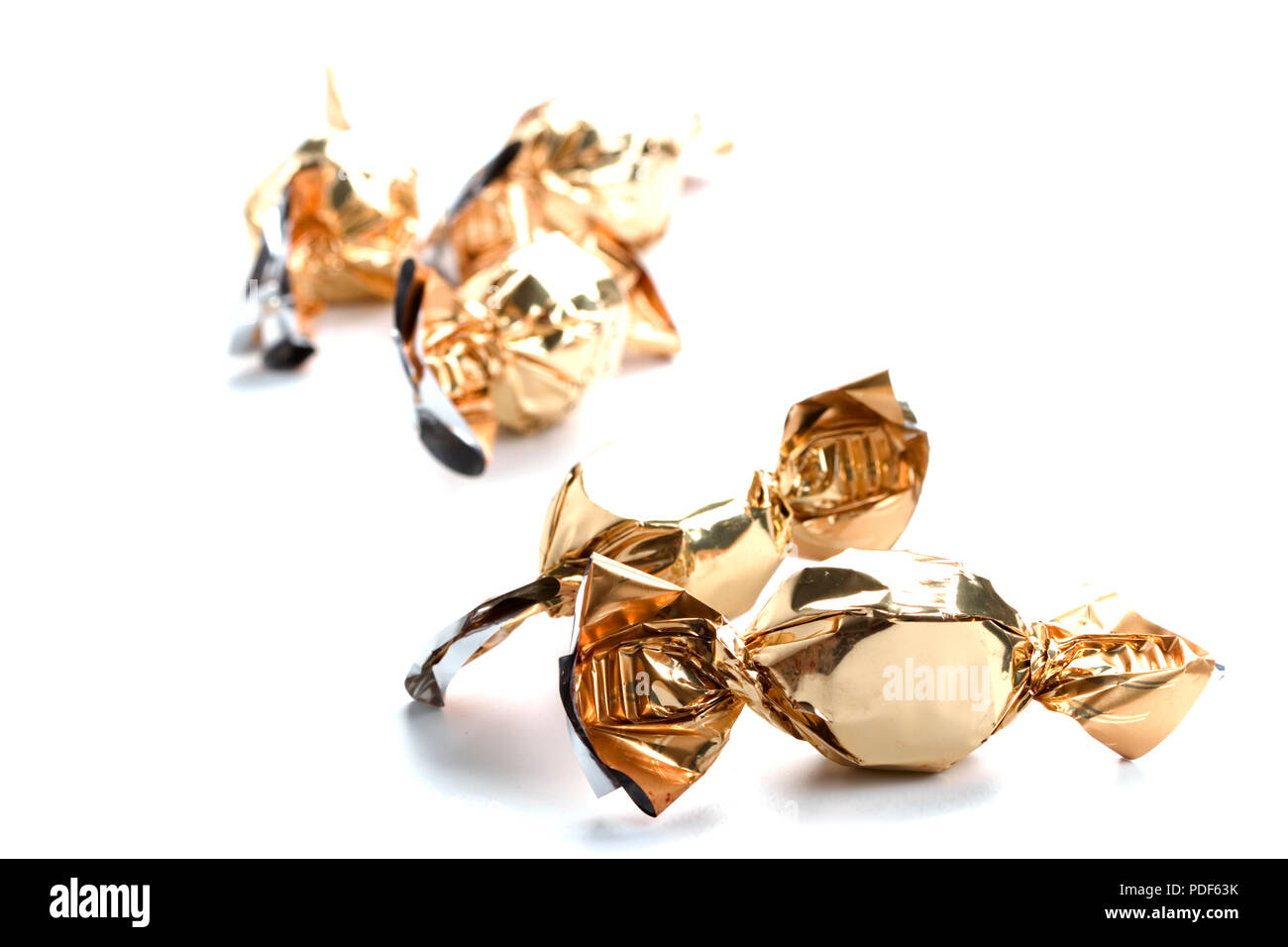 golden sweets closeup on white background Stock Photo - Alamy