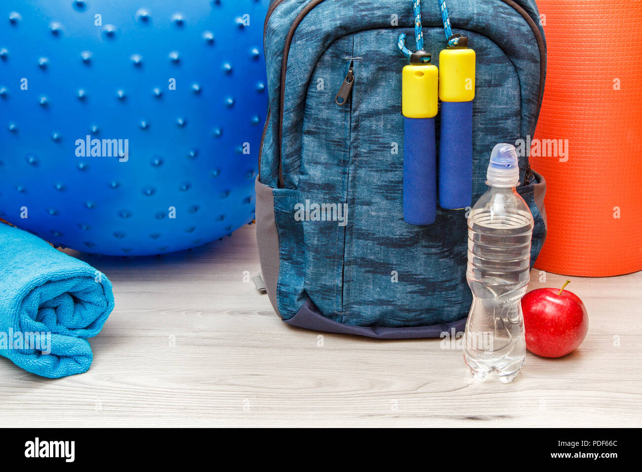 Different tools for fitness in room or gym on grey floor Stock Photo ...