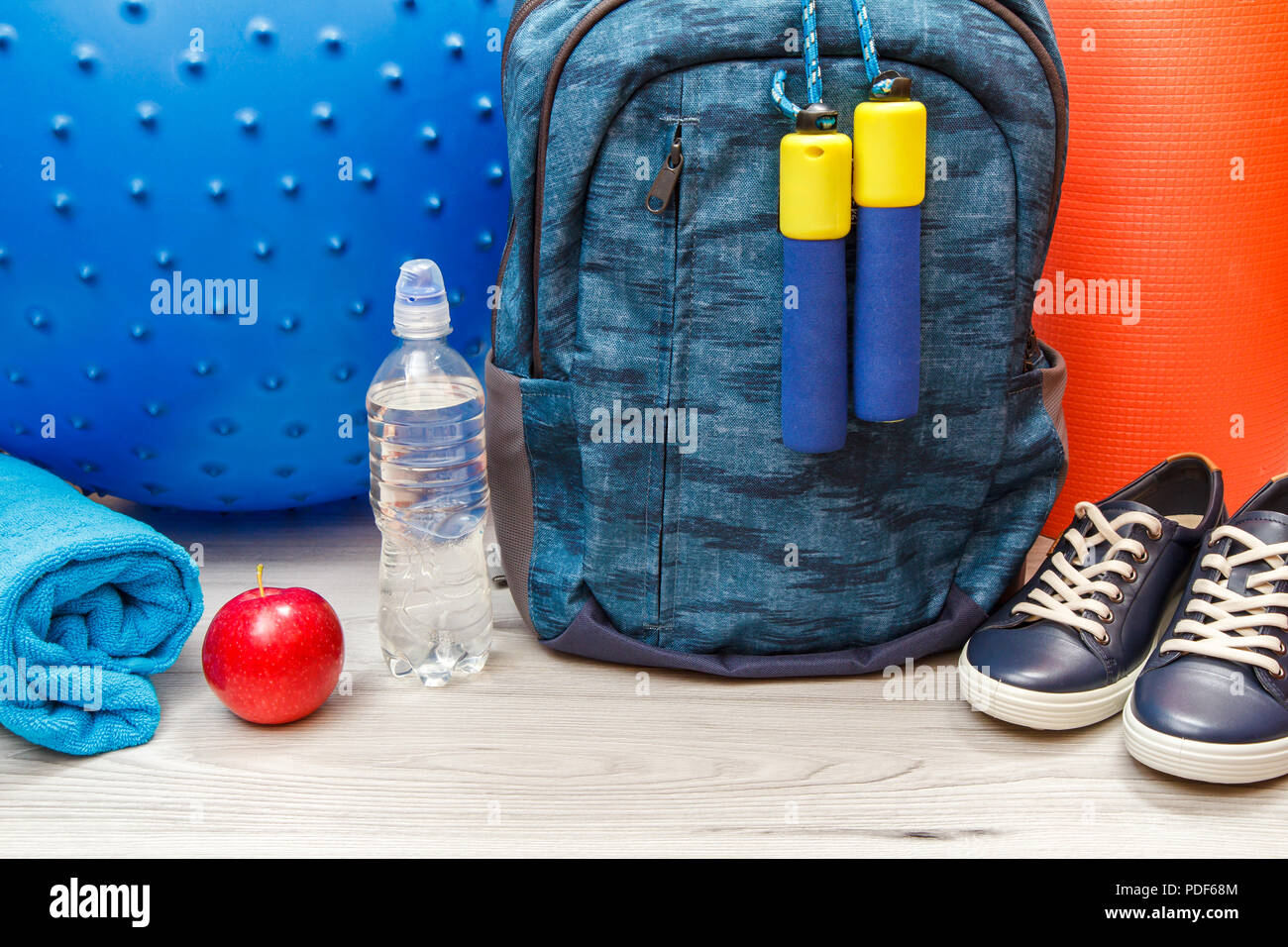 Different tools for fitness in room or gym on grey floor Stock Photo ...