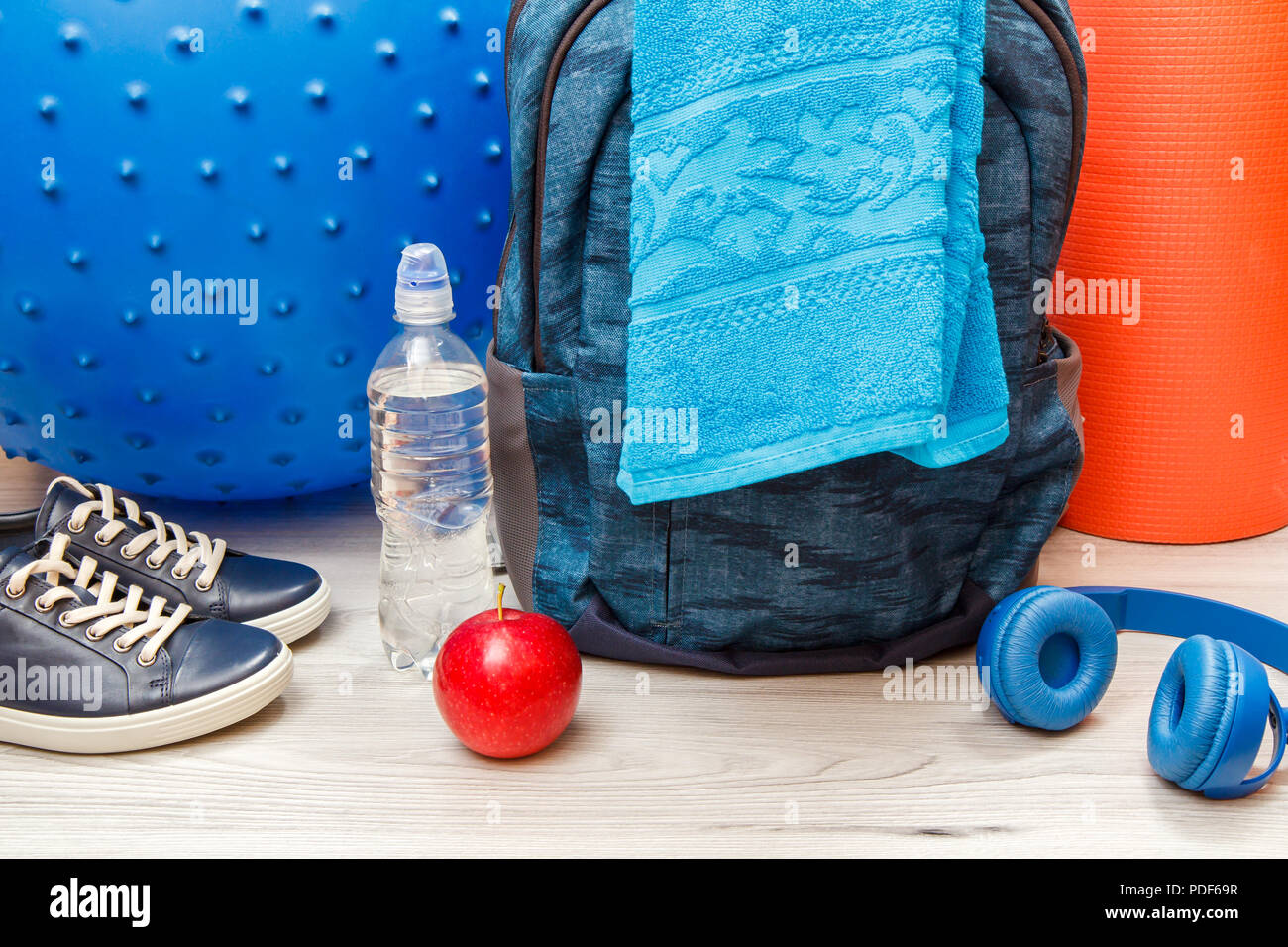 Different tools for fitness in room or gym on grey floor Stock Photo ...