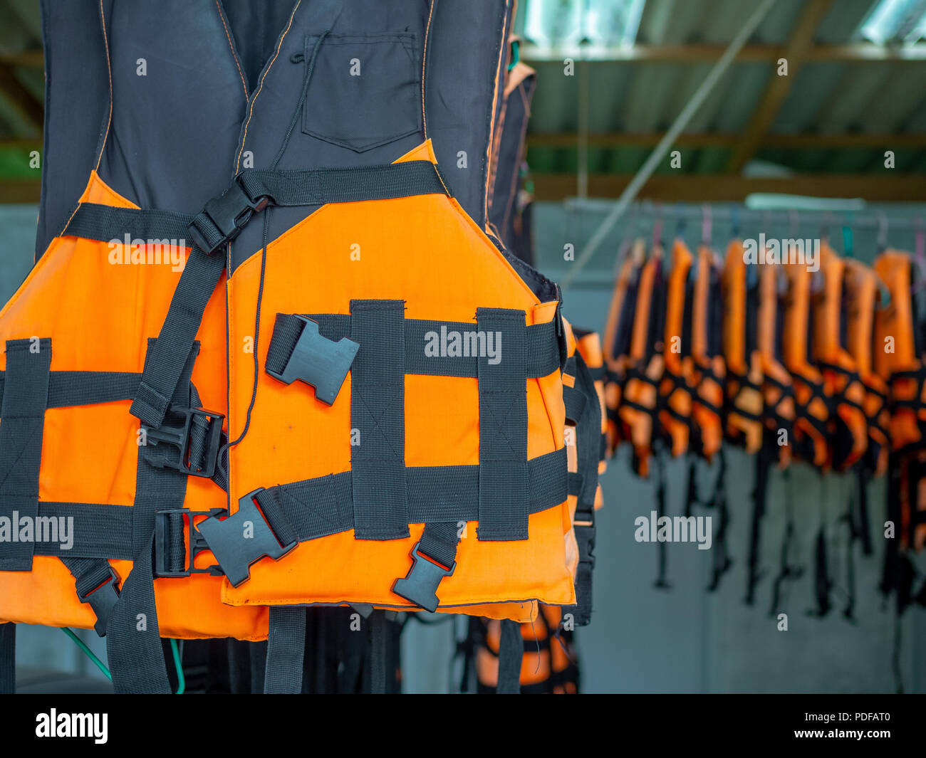 Life jackets safety equipment hanging on the bars for the tourism ...