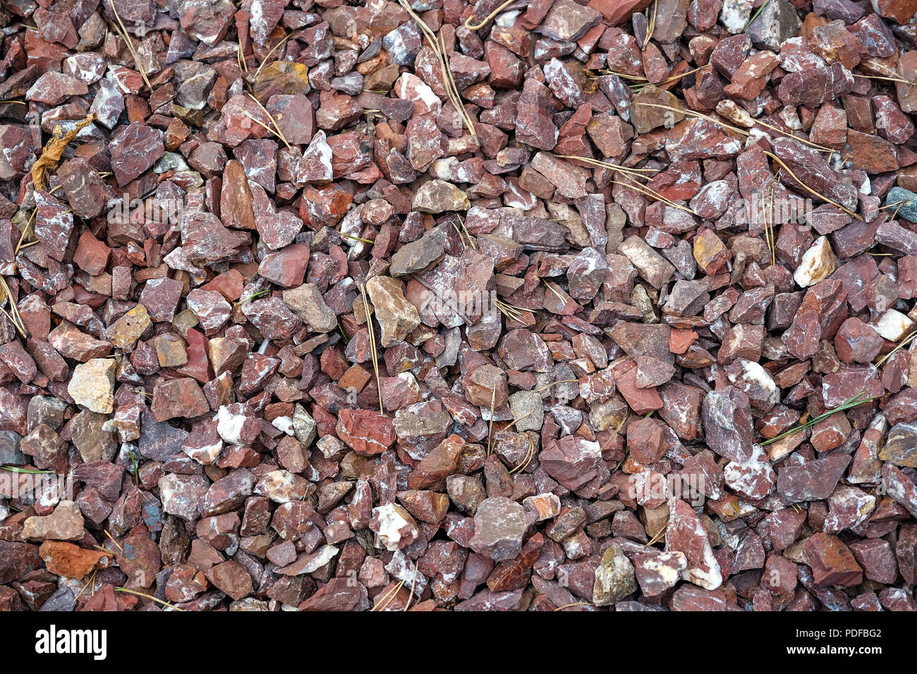 This is a crushed red stone background. White crushed stone. Gravel ...