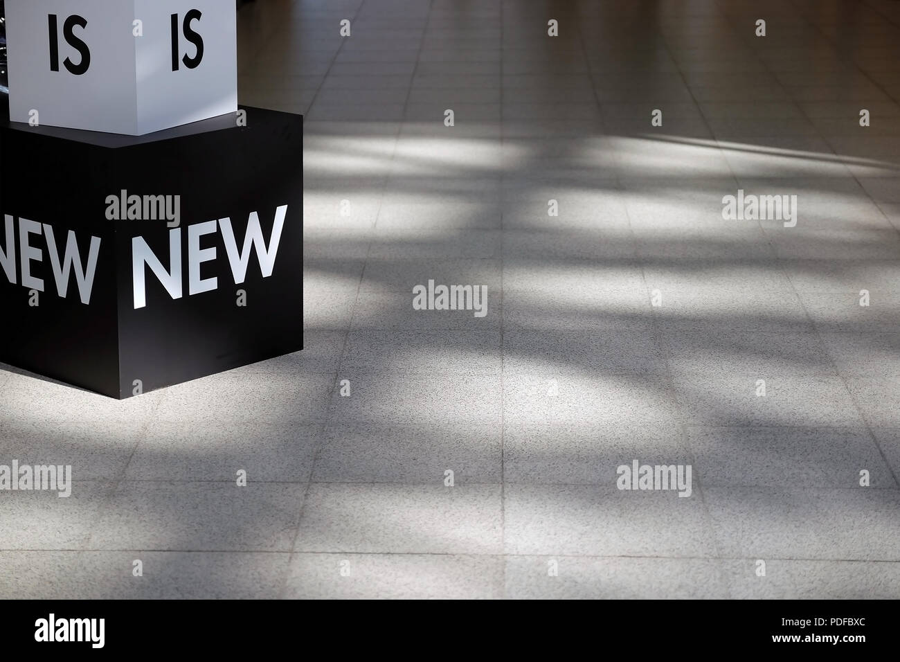 Cubes on the floor with inscriptions. Black big little white on top ...
