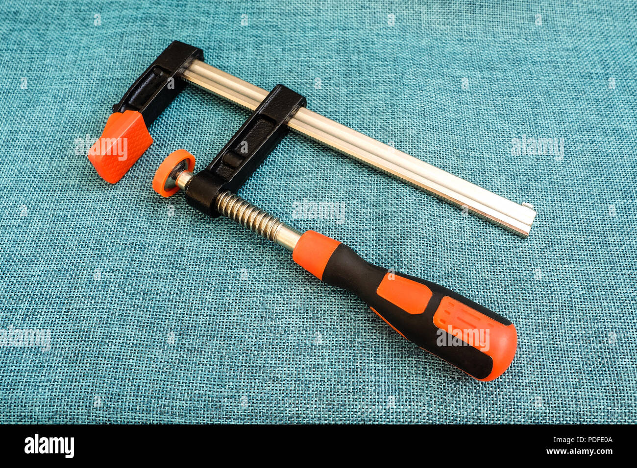 The metal clamp on a wooden carpenter's clips. Clamp on burlap ...