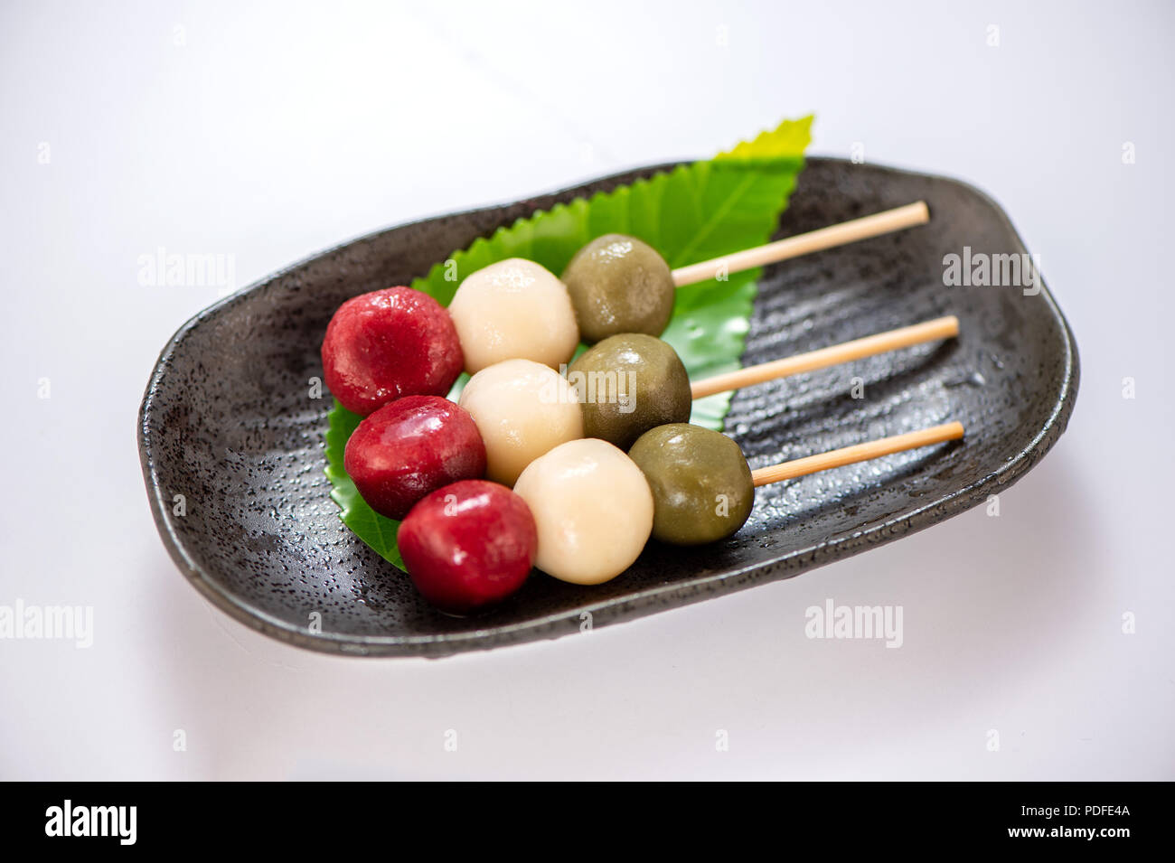 Japanese Dango dessert with 3 different color in pink(red), white, and ...