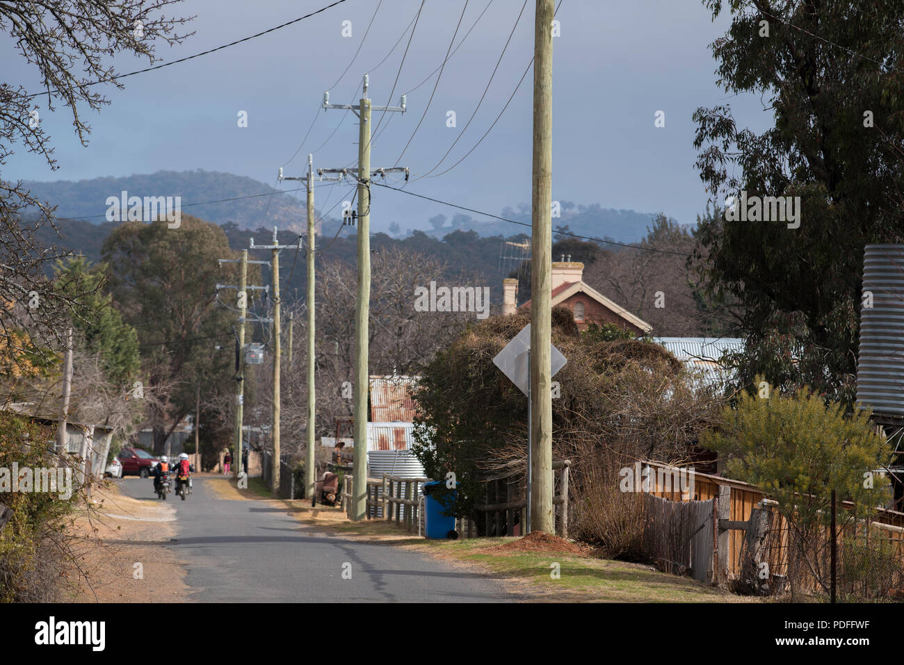 New timber power poles run the length of this narrow country lane in ...