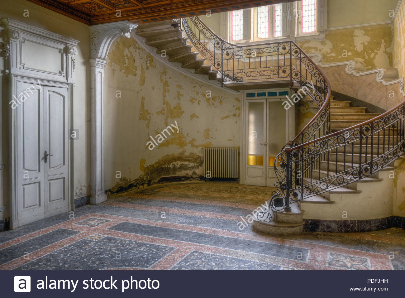 Decaying interior of an abandoned building with peeling paint and ...