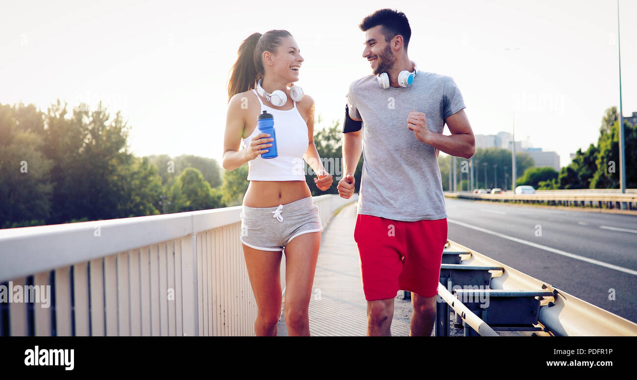 Athletic couple jogging in nature Stock Photo - Alamy