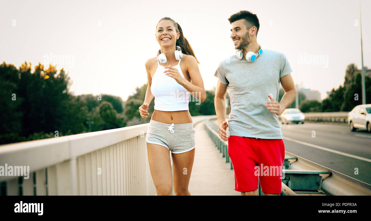 City running couple jogging outside Stock Photo - Alamy
