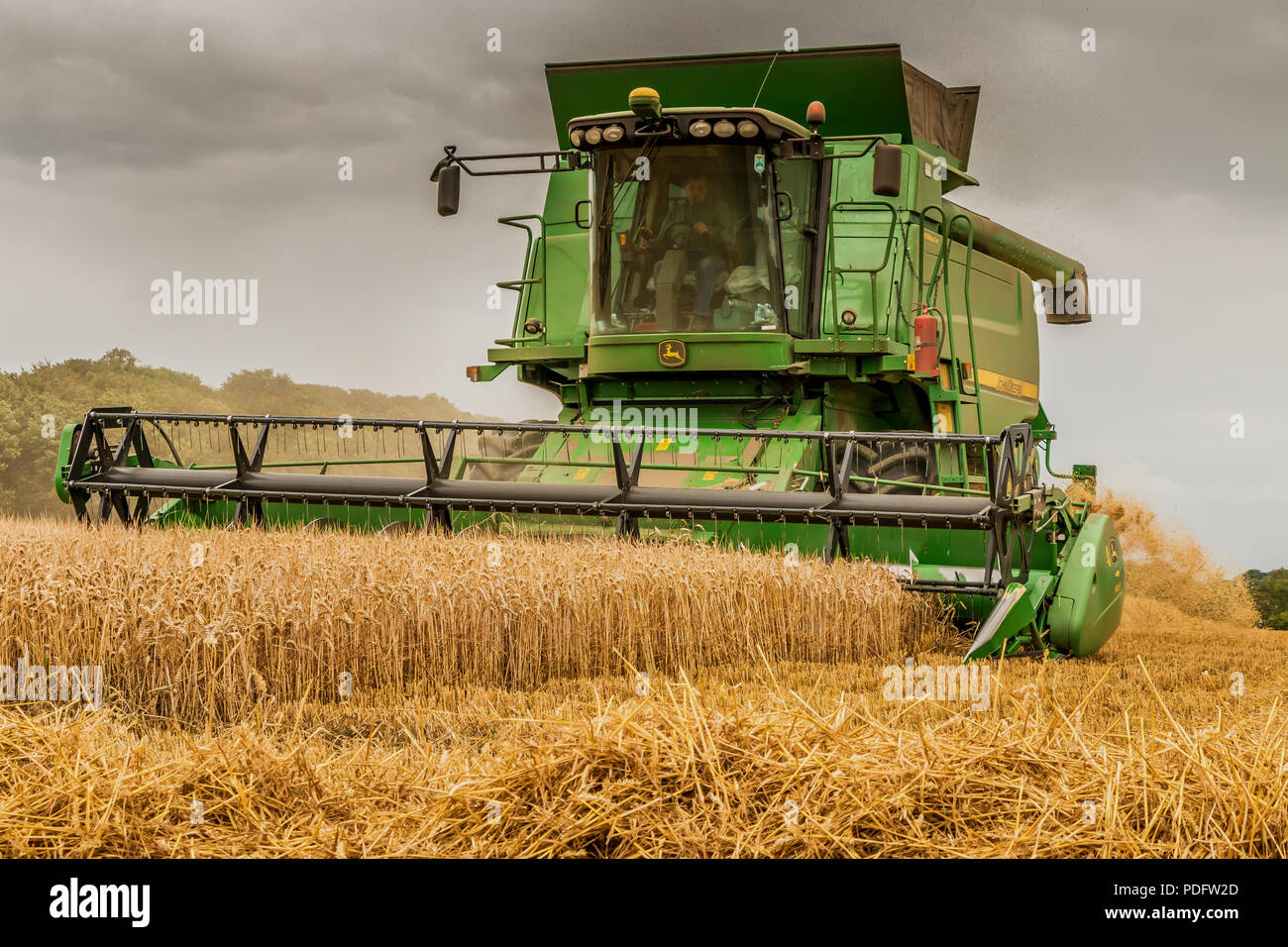 John deere combine harvester harvesting wheat hi-res stock photography ...