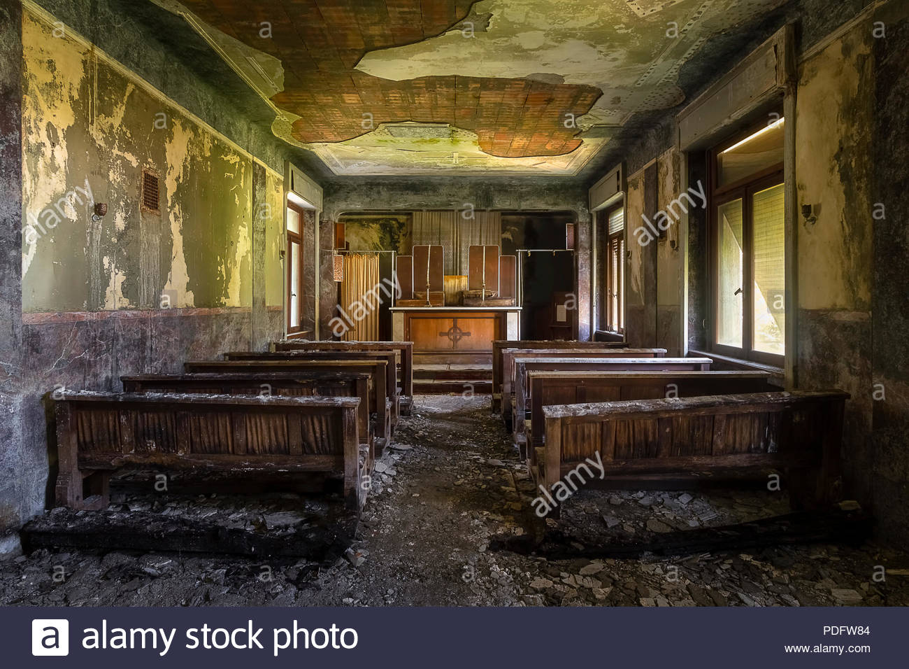 Decaying interior of an abandoned building with peeling paint and ...
