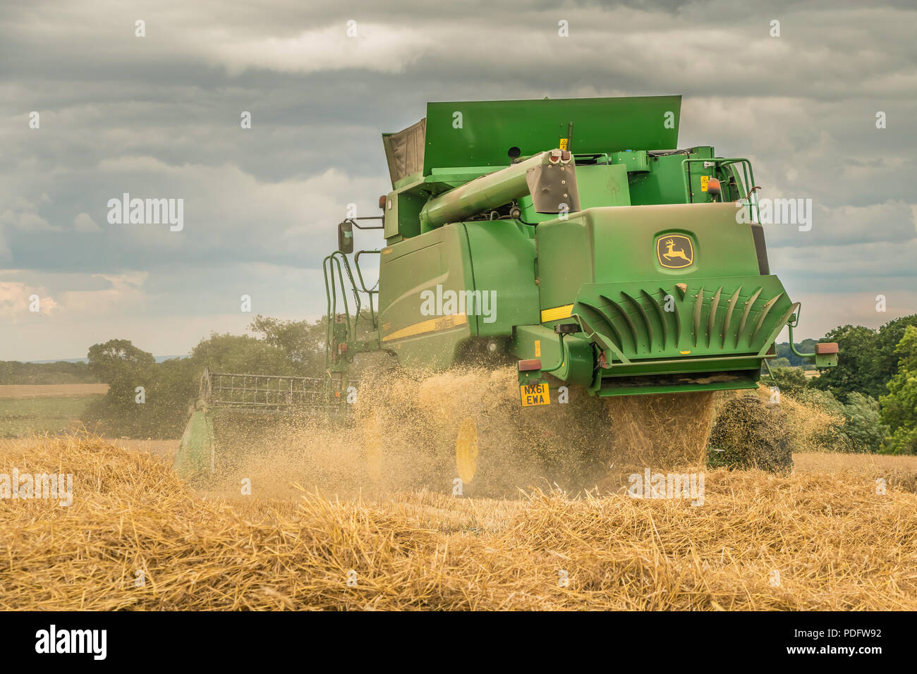 John deere combine harvester harvesting wheat hi-res stock photography ...