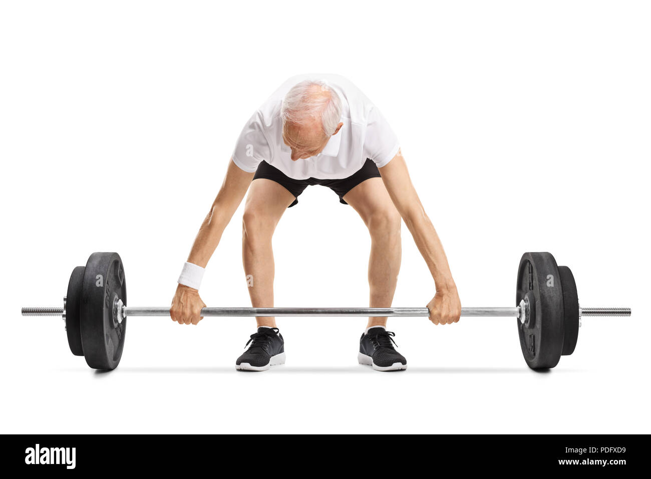 Elderly man preparing to lift a barbell isolated on white background ...
