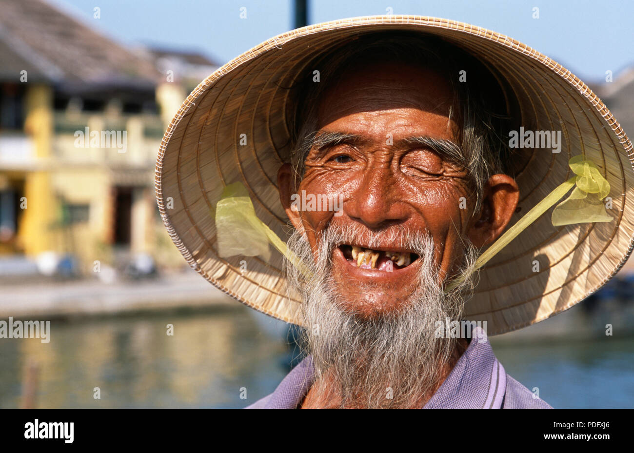 Close-up of the face of smiling fisherman on the Thu Bhon river at Hoi ...