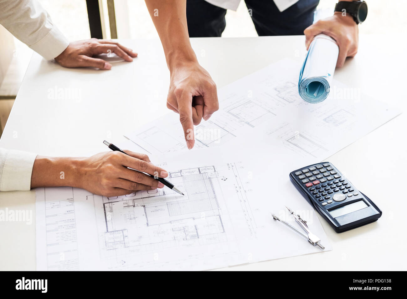 Close-up Of Person's engineer Hand Drawing Plan On Blue Print with ...